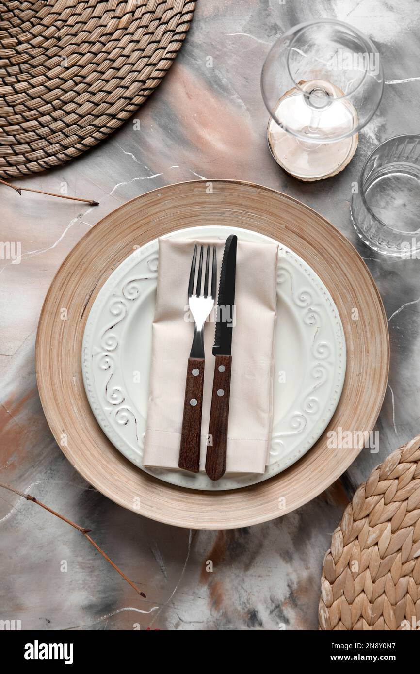Beautiful table setting with plates and cutlery on grunge background ...