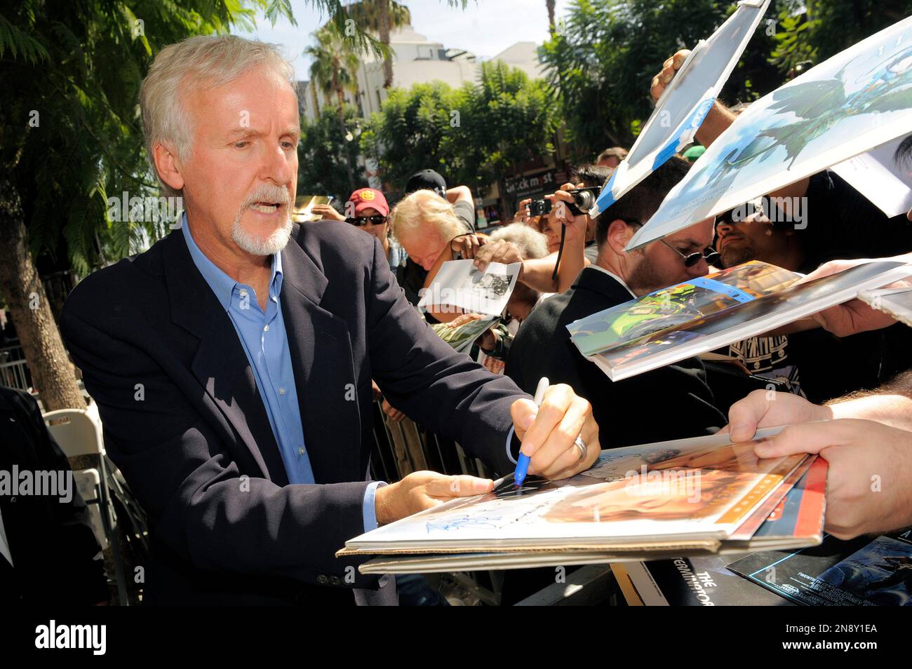 Director James Cameron signs autographs for fans following a ceremony ...
