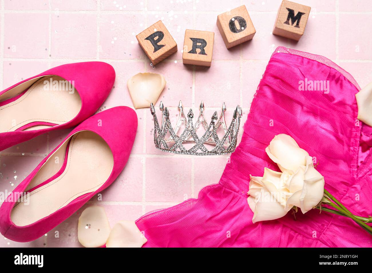 Word PROM with tiara, dress, heels and roses on pink tile background ...