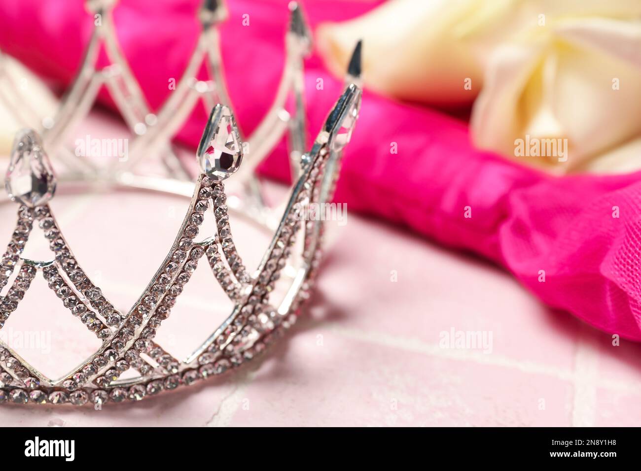 Beautiful tiara on pink tile table, closeup. Prom concept Stock Photo ...