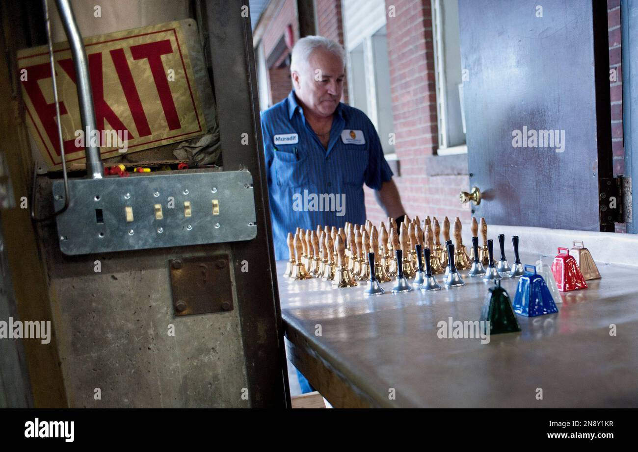Production supervisor Muradif Abidovic carries a table of bells out a ...