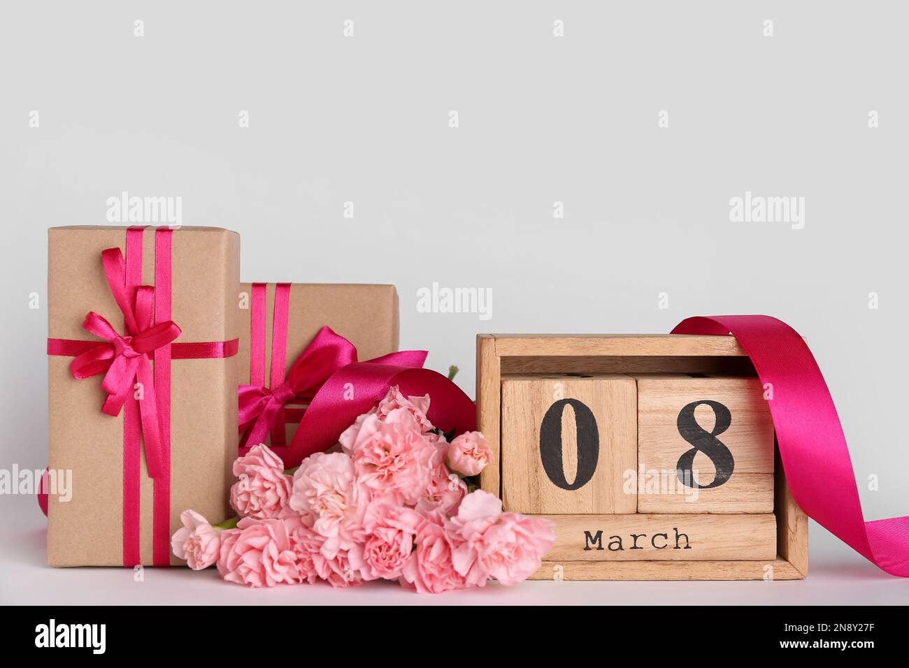 Cube calendar with date MARCH 8, gift boxes and beautiful carnation ...