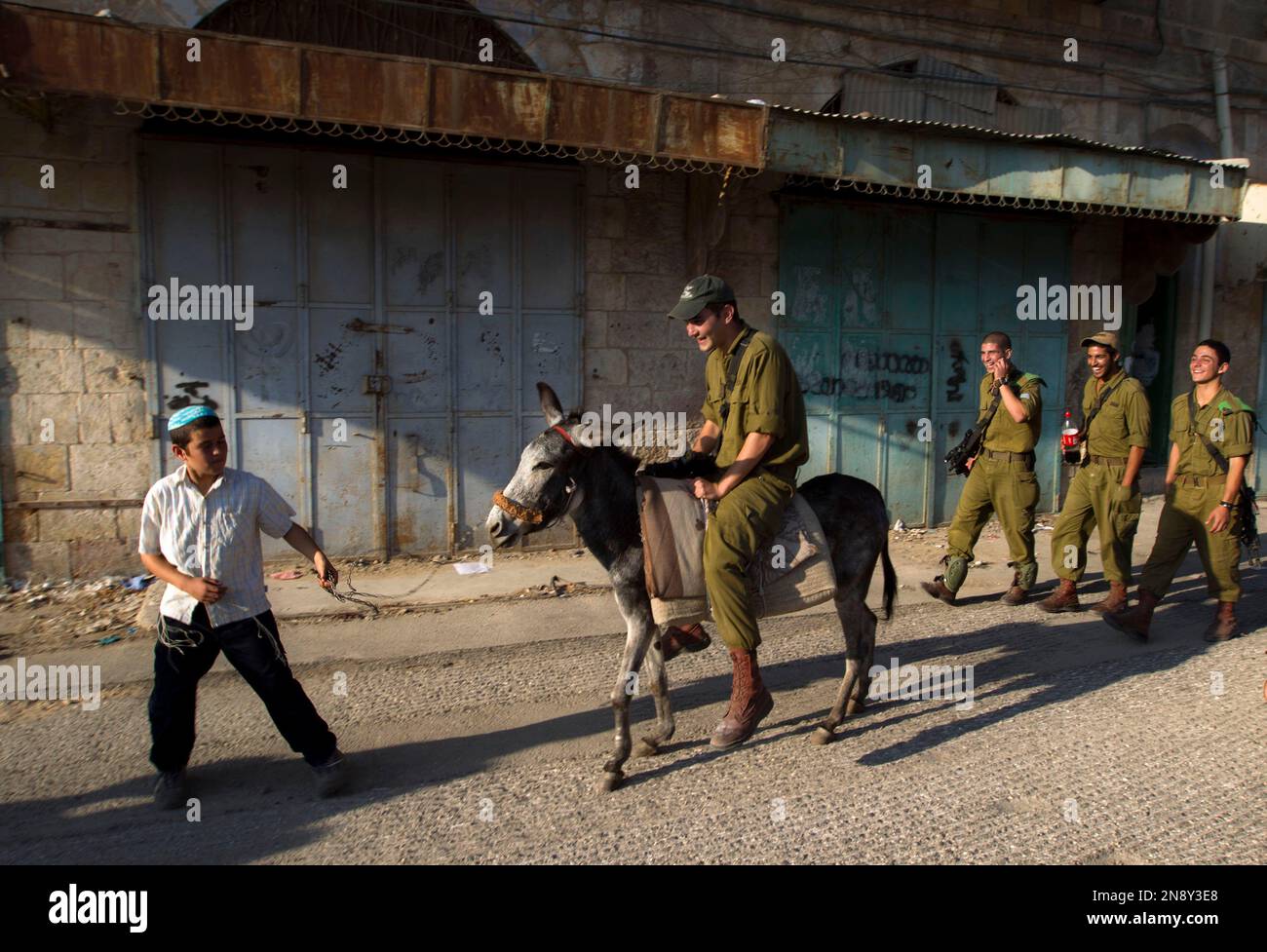 An Israeli soldier rides a donkey during a celebration of the holiday ...