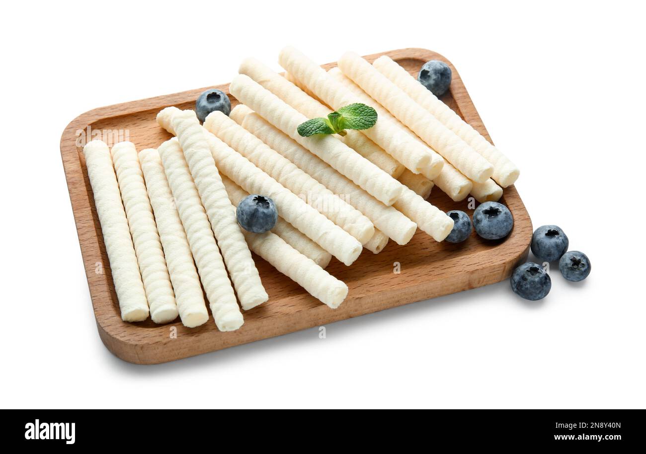 Board with delicious wafer rolls, blueberries and mint isolated on ...