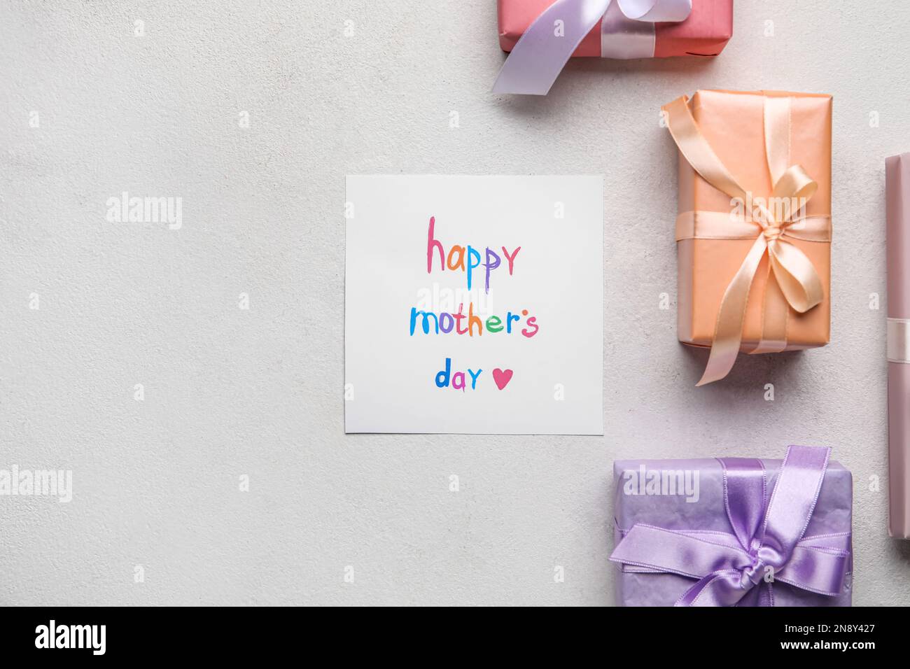 Card with text HAPPY MOTHER'S DAY and gift boxes on light background ...
