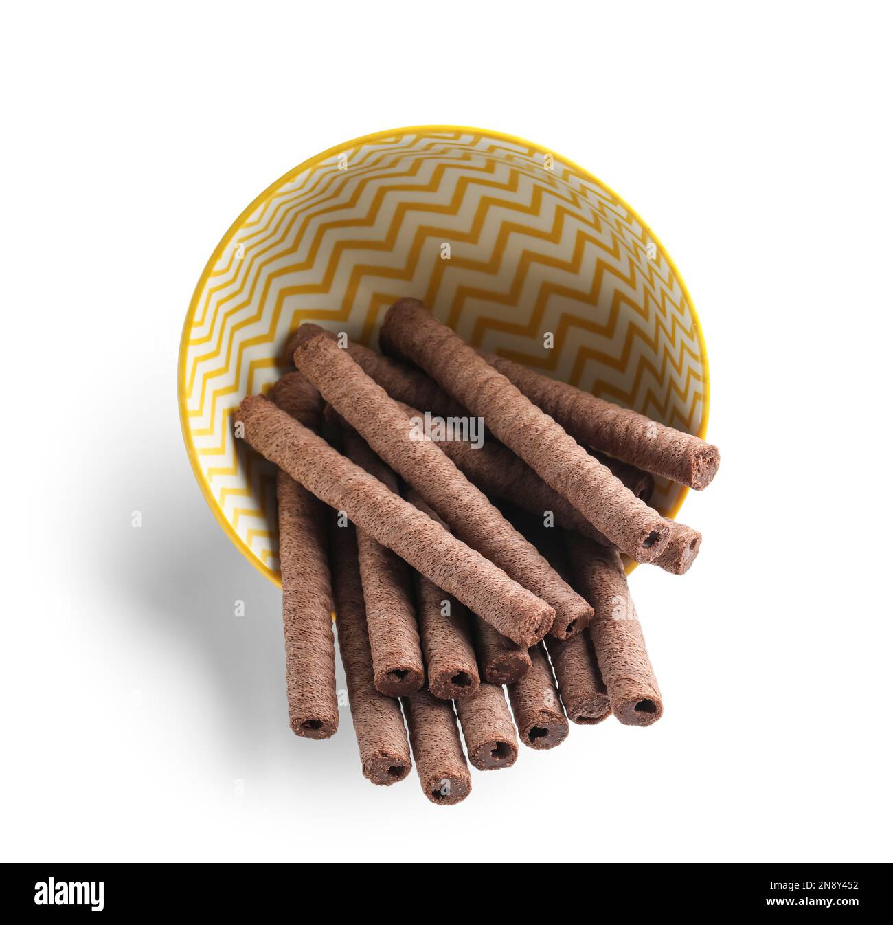 Bowl with delicious chocolate wafer rolls isolated on white background ...