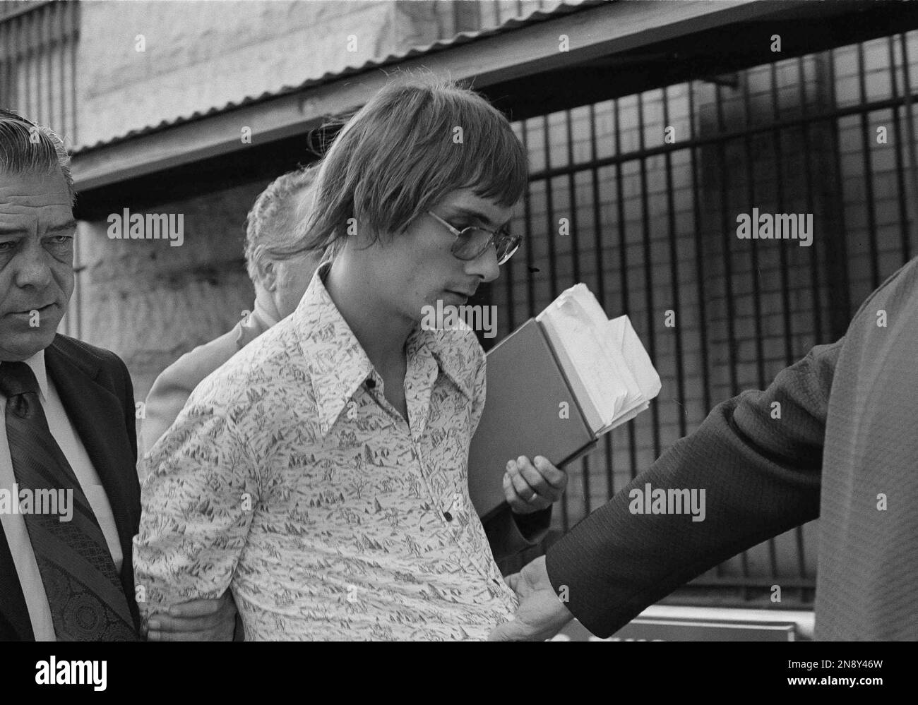 Douglas Gretzler, 22, is escorted by police at the city jail after ...