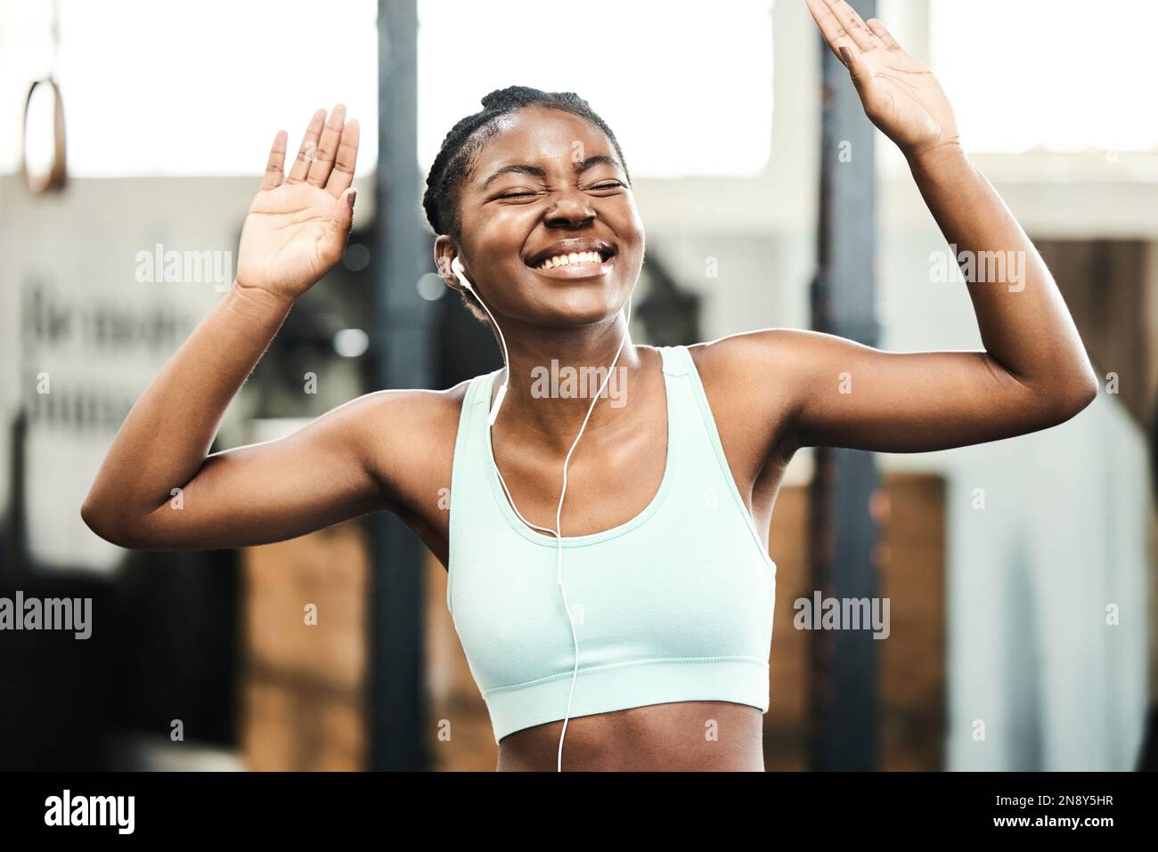 Being fit makes me want to dance. an attractive young woman dancing in ...