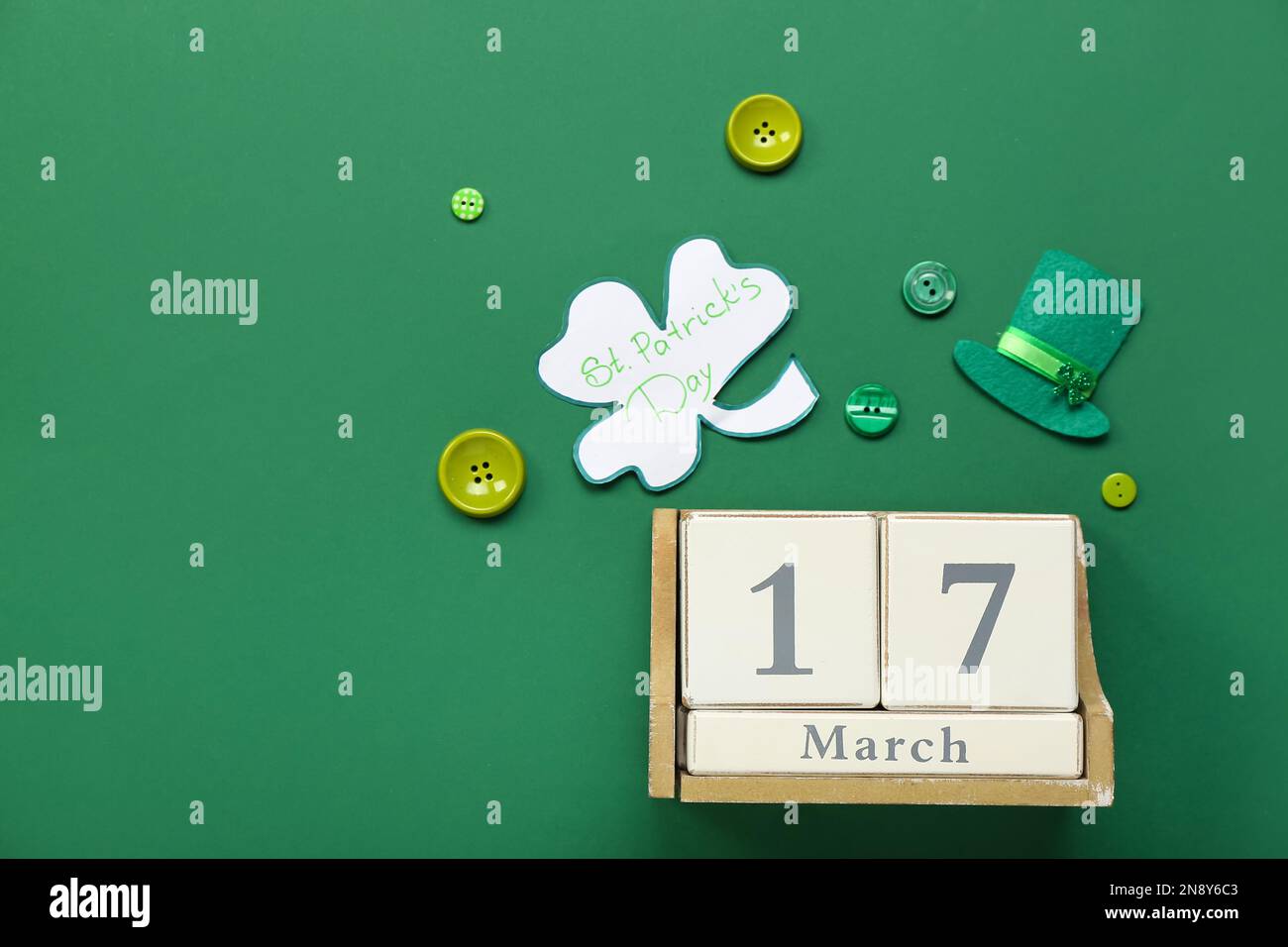 Calendar with date of St. Patrick's Day, paper leprechaun hat, clover ...