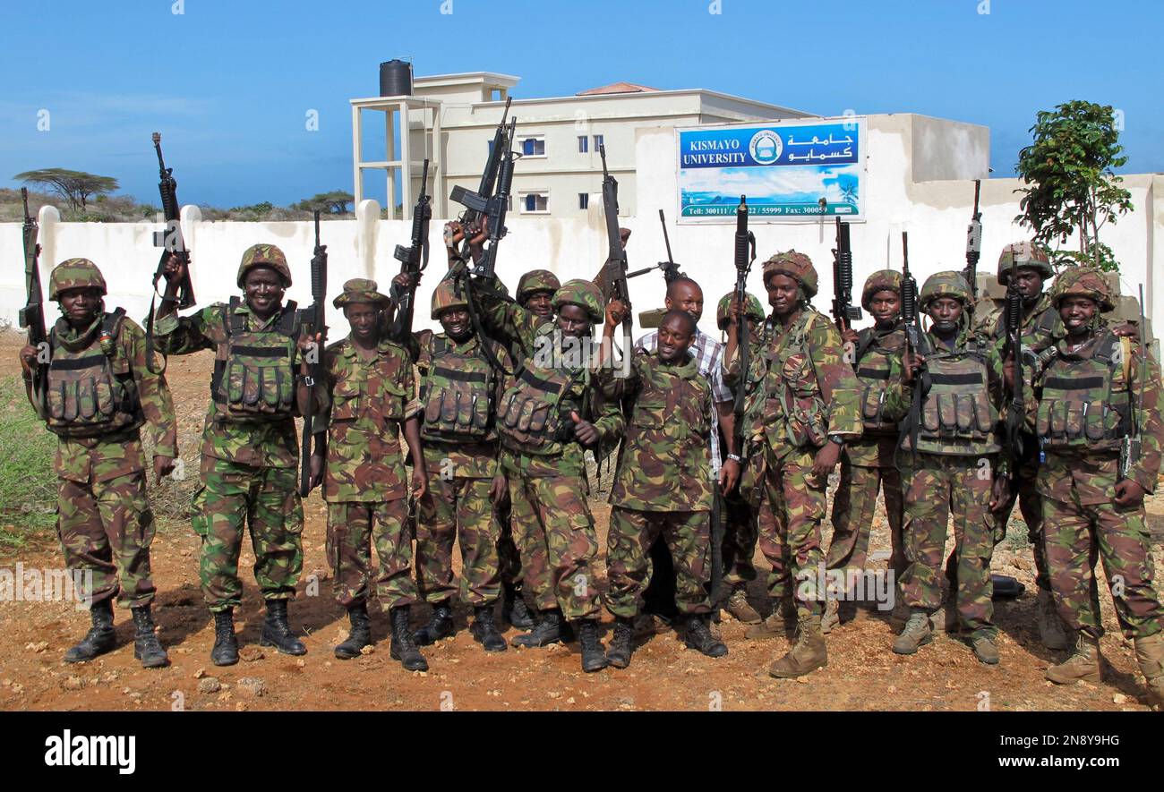 Kenyan soldiers pose for their colleagues to take pictures of them as they sing and celebrate ...