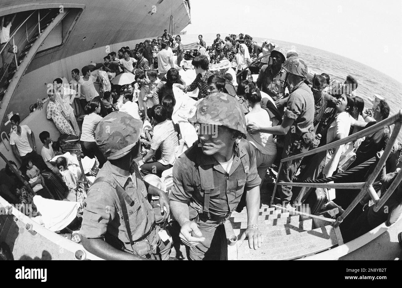 South Vietnamese evacuees fill a landing craft, assisted by U.S ...