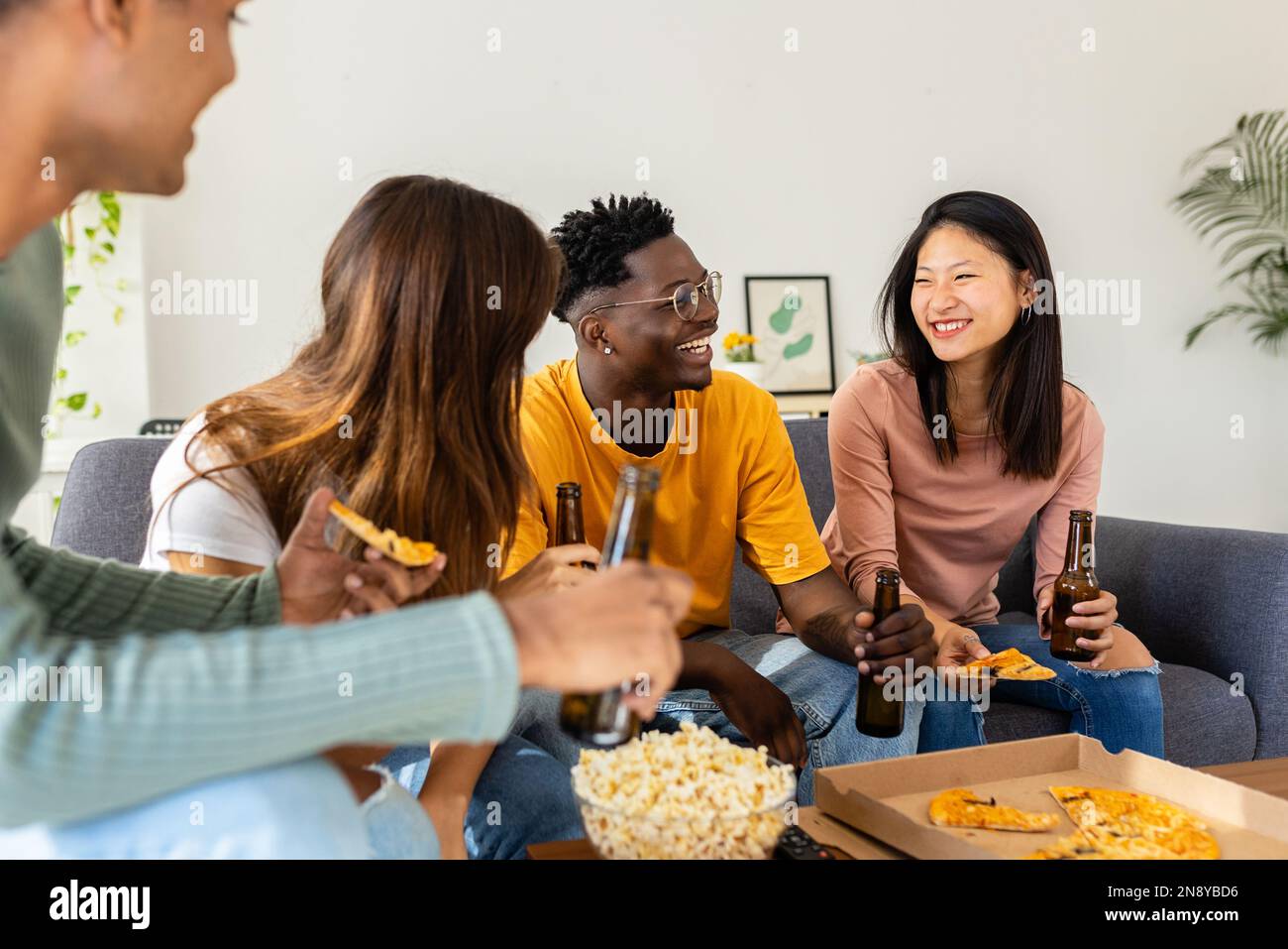 Group of friends having fun at lunch eating pizza and drinking beer ...