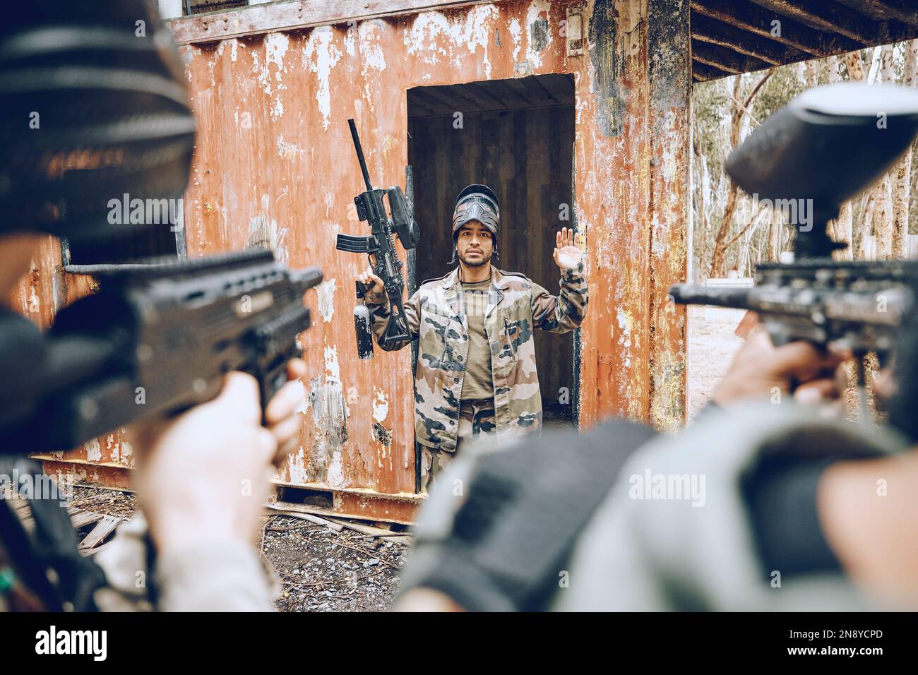Paintball, man surrender with soldier and gun, battlefield and fitness ...