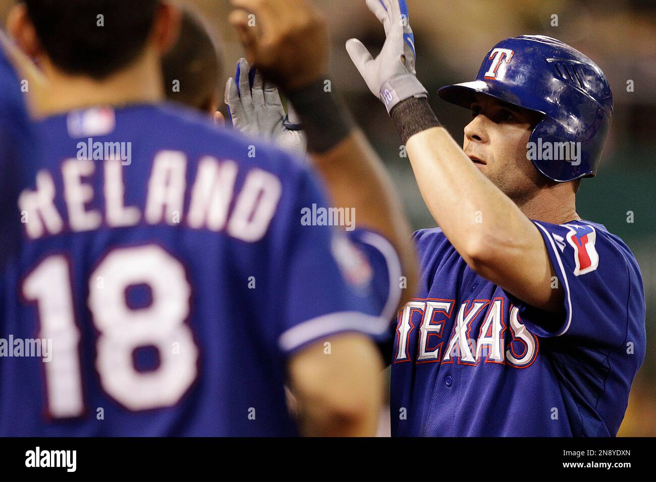 Texas Rangers' Michael Young, right, is congratulated after hitting a ...