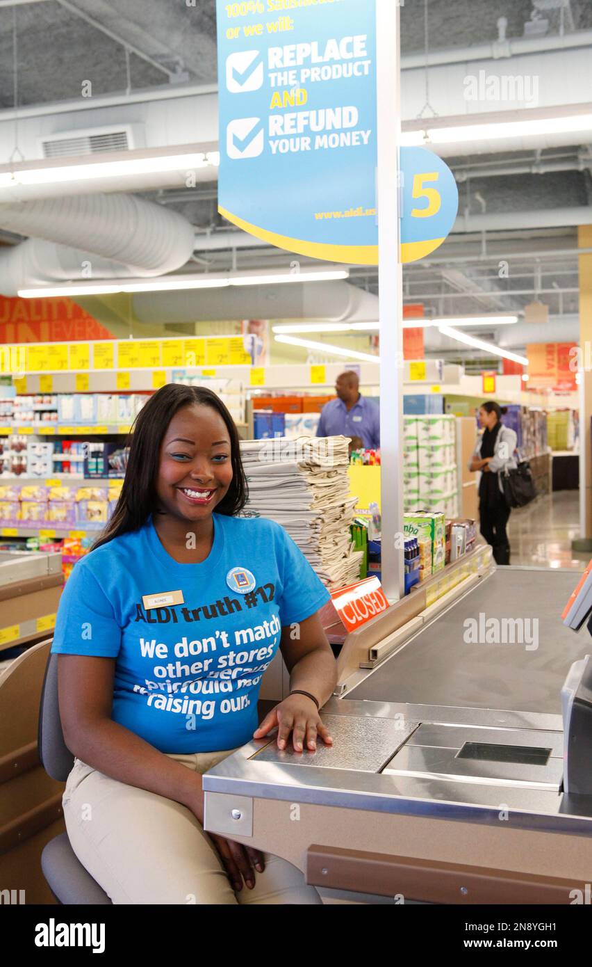 ALDI employee Alonee waits for customers at the checkout counter at the ...