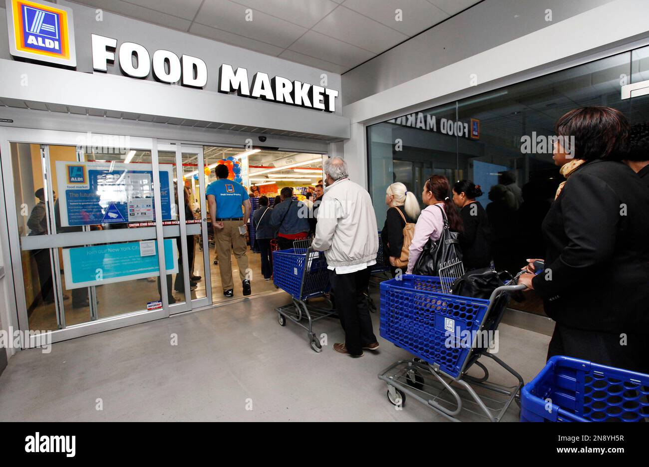 IMAGE DISTRIBUTED FOR ALDI - Customers line-up to shop at the grand opening of the first ALDI ...