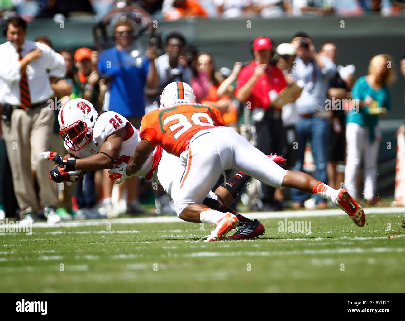 Miami's A.J. Highsmith (30) tackles North Carolina State's Tony Creecy ...