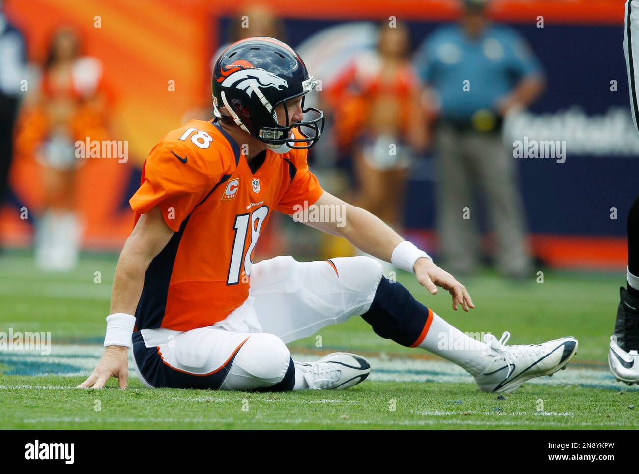 Denver Broncos quarterback Peyton Manning gets up after being hit by ...