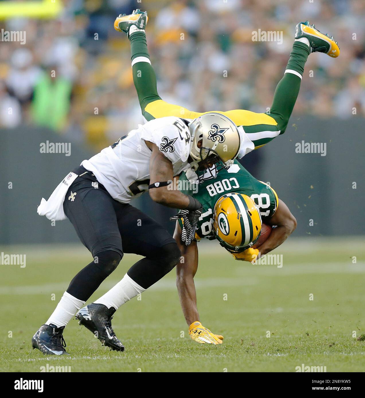 Green Bay Packers' Randall Cobb is upended by New Orleans Saints' Corey ...