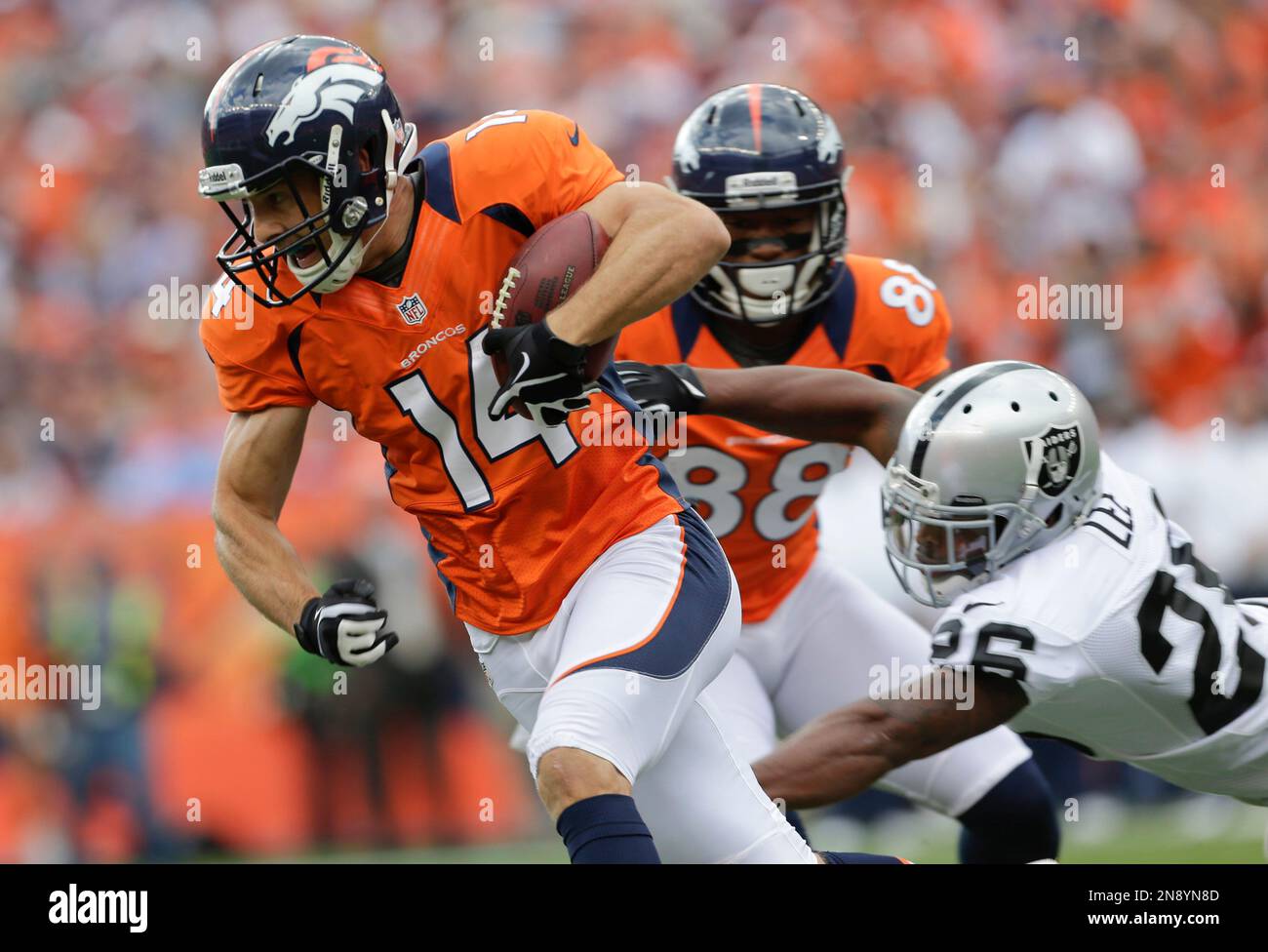 Denver Broncos wide receiver Brandon Stokley (14) turns the ball up ...