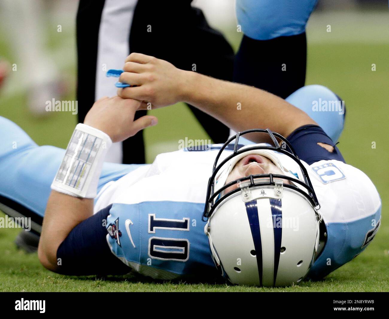 Tennessee Titans quarterback Jake Locker holds his finger after being ...