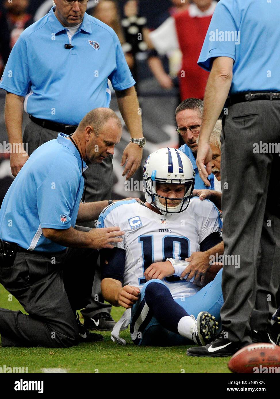 Tennessee Titans quarterback Jake Locker (10) is helped off the field ...