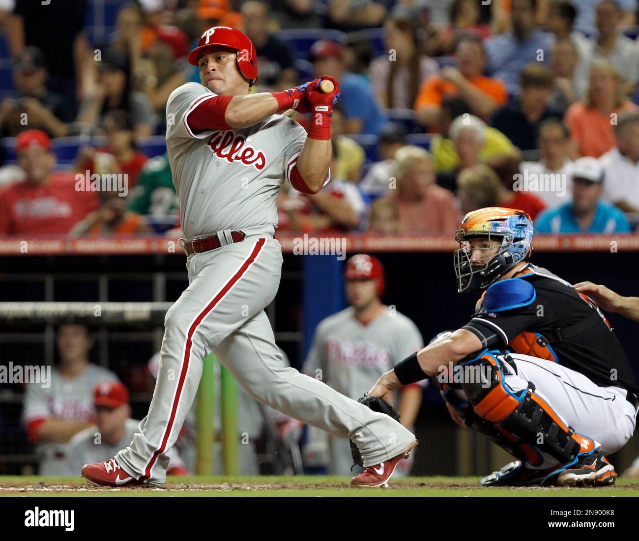 Philadelphia Phillies' Carlos Ruiz, left, follows through as Miami ...