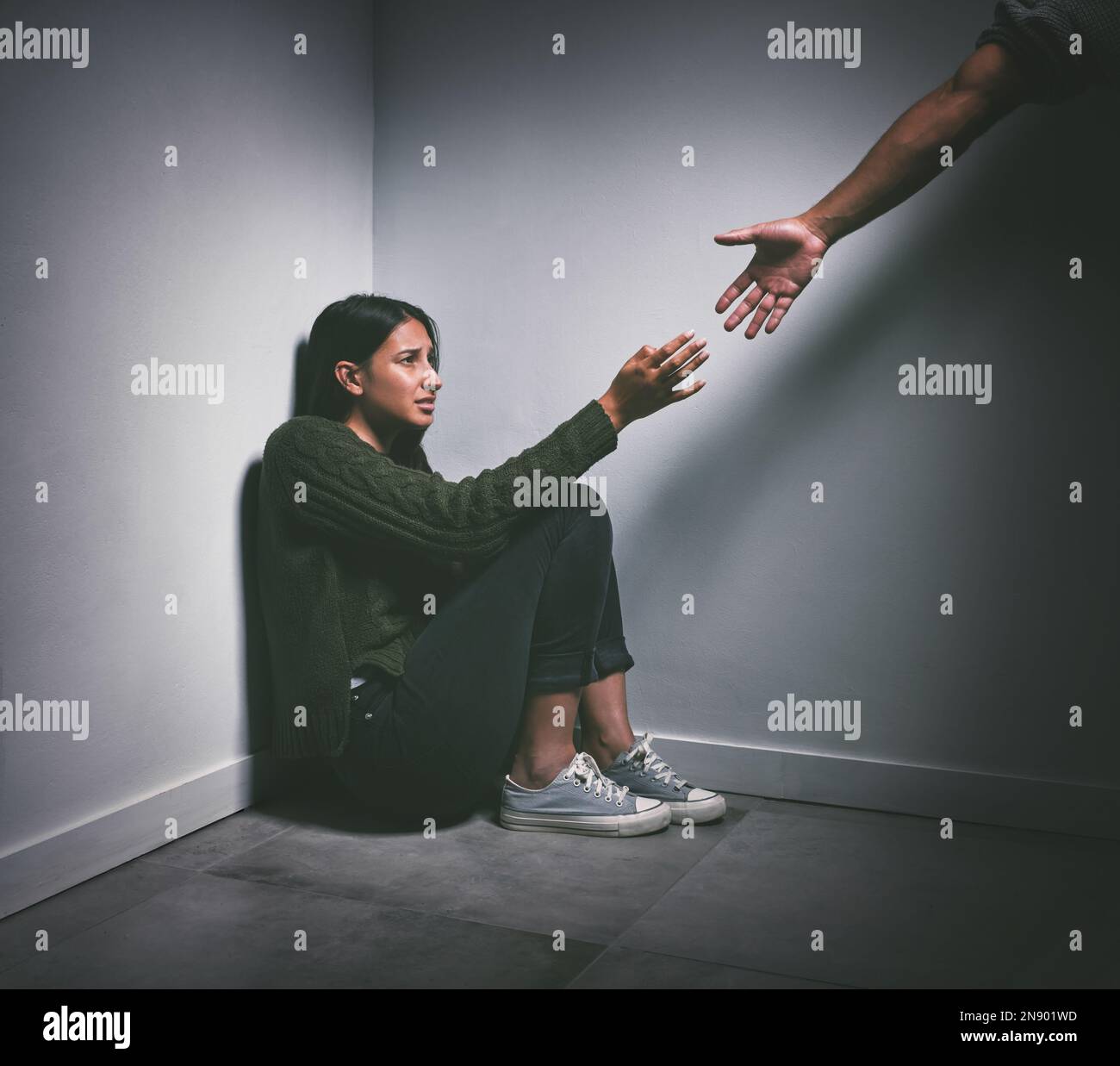 Hang in there, help is here. a young woman sitting in the corner of a ...