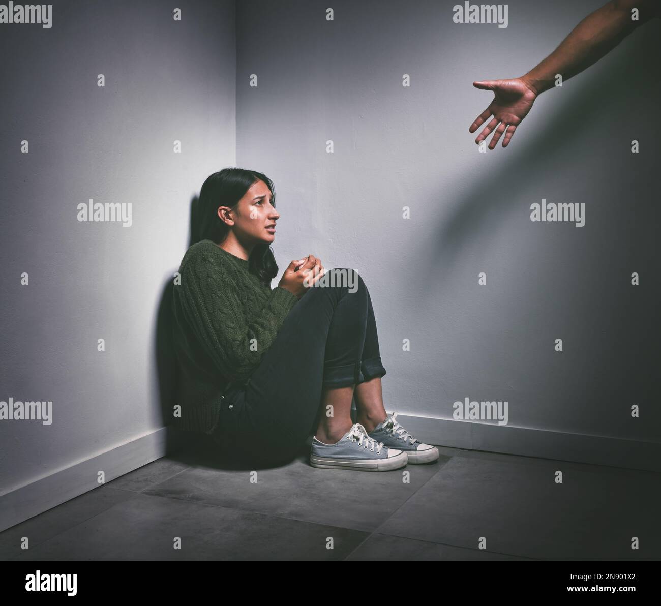You dont have to suffer alone. a young woman sitting in the corner of a ...