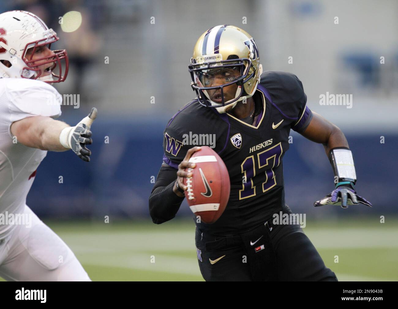 Washington quarterback Keith Price looks to throw in an NCAA college ...