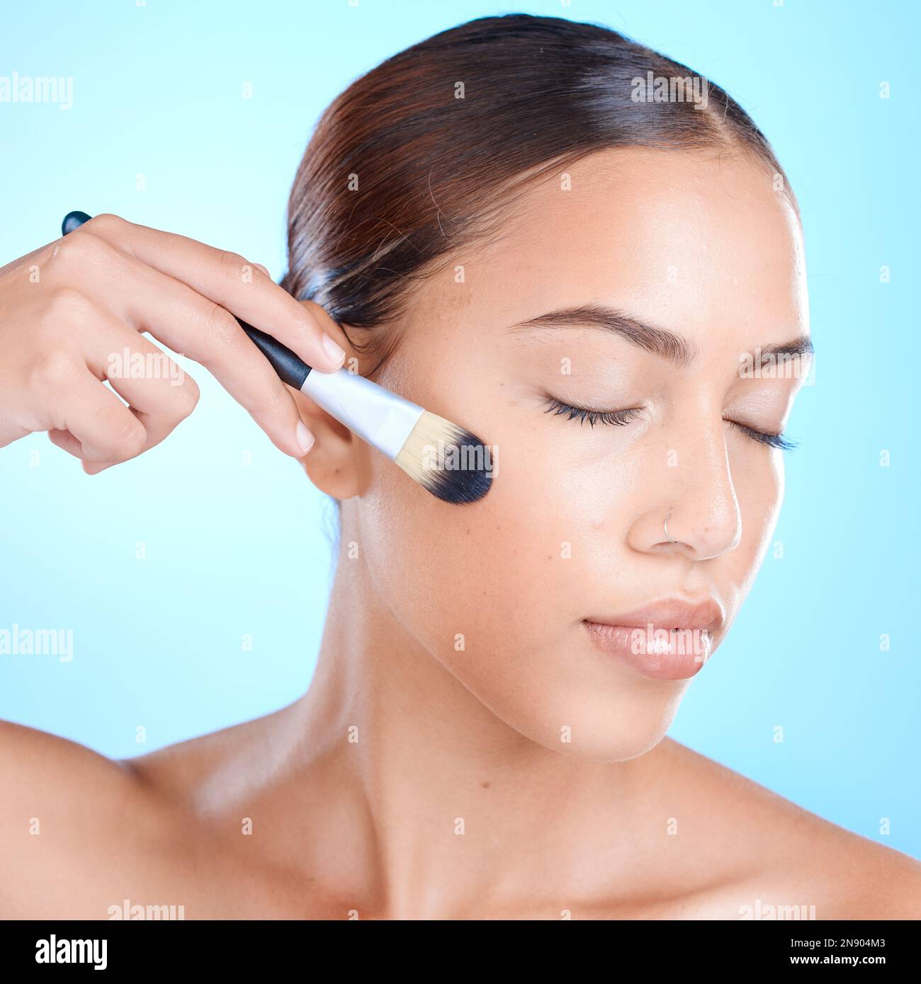 Makeup brush, cosmetics tool and woman face with makeup and blush in a ...
