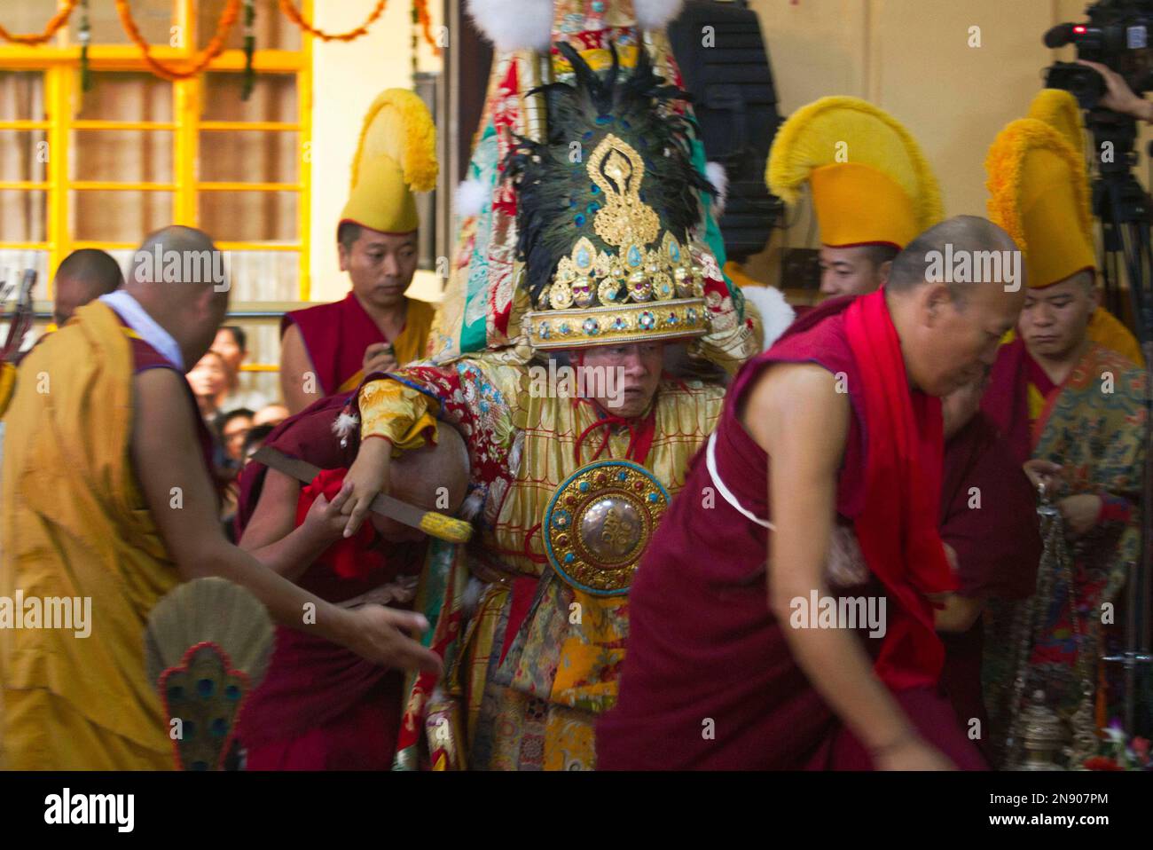 Monks rush to contain Nechung, the Tibetan state oracle, as he moves in ...