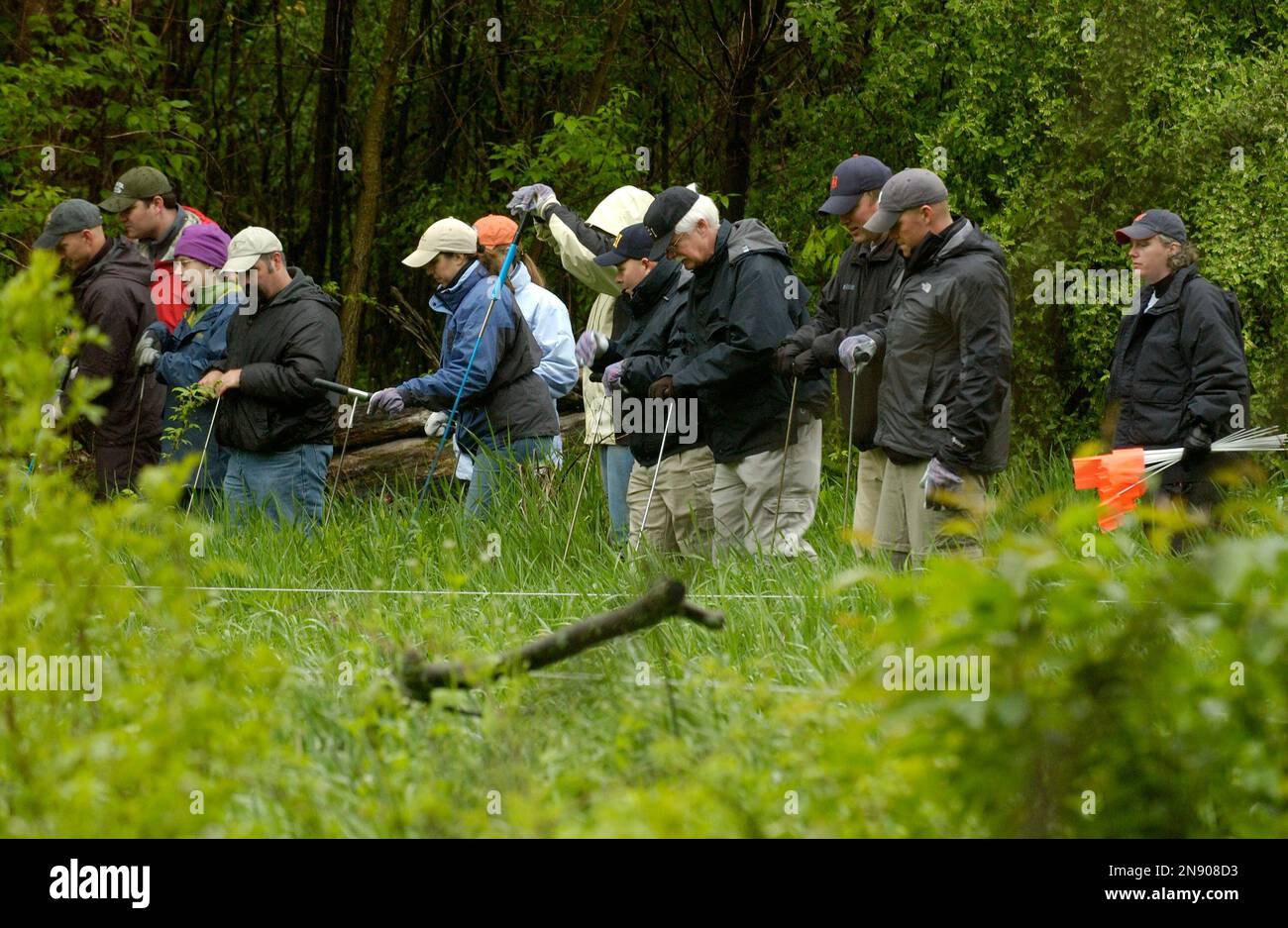 FILE - In this May 19, 2006, file photo, searchers in formation inspect ...