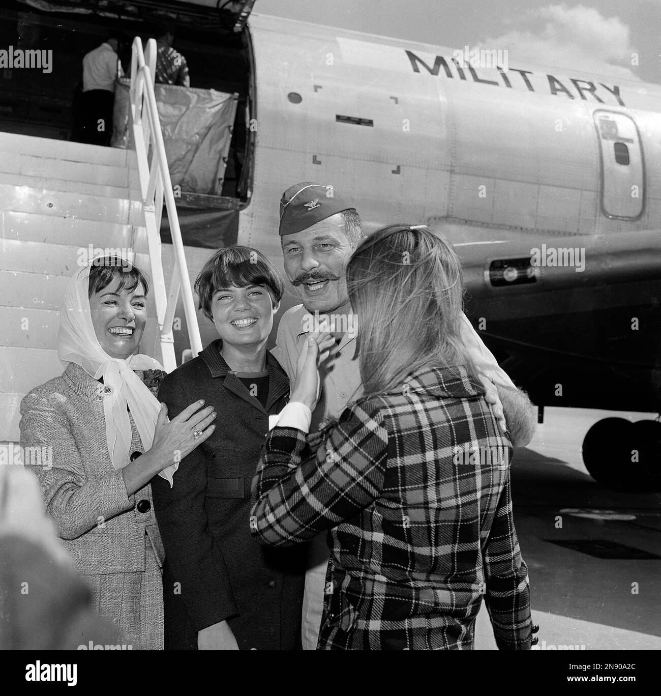 U.S. Air Force Col. Robin Olds gets a warm greeting from his family at ...