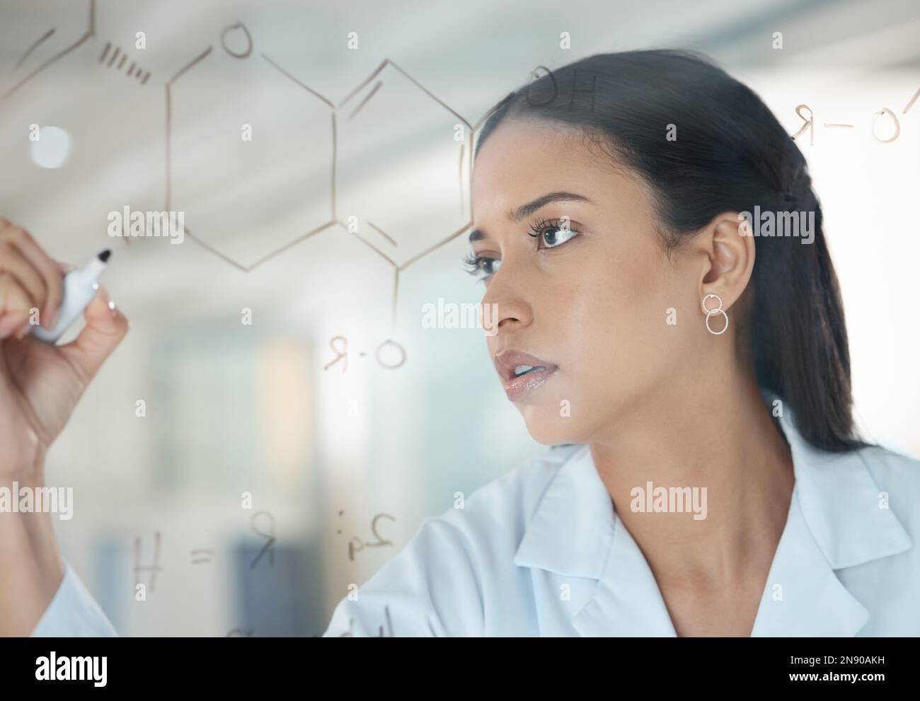 Developing a working cure takes hard work. a young scientist solving ...