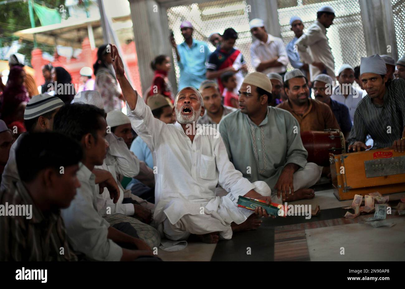 A Muslim devotee joins a group of religious singers during a qawwali ...