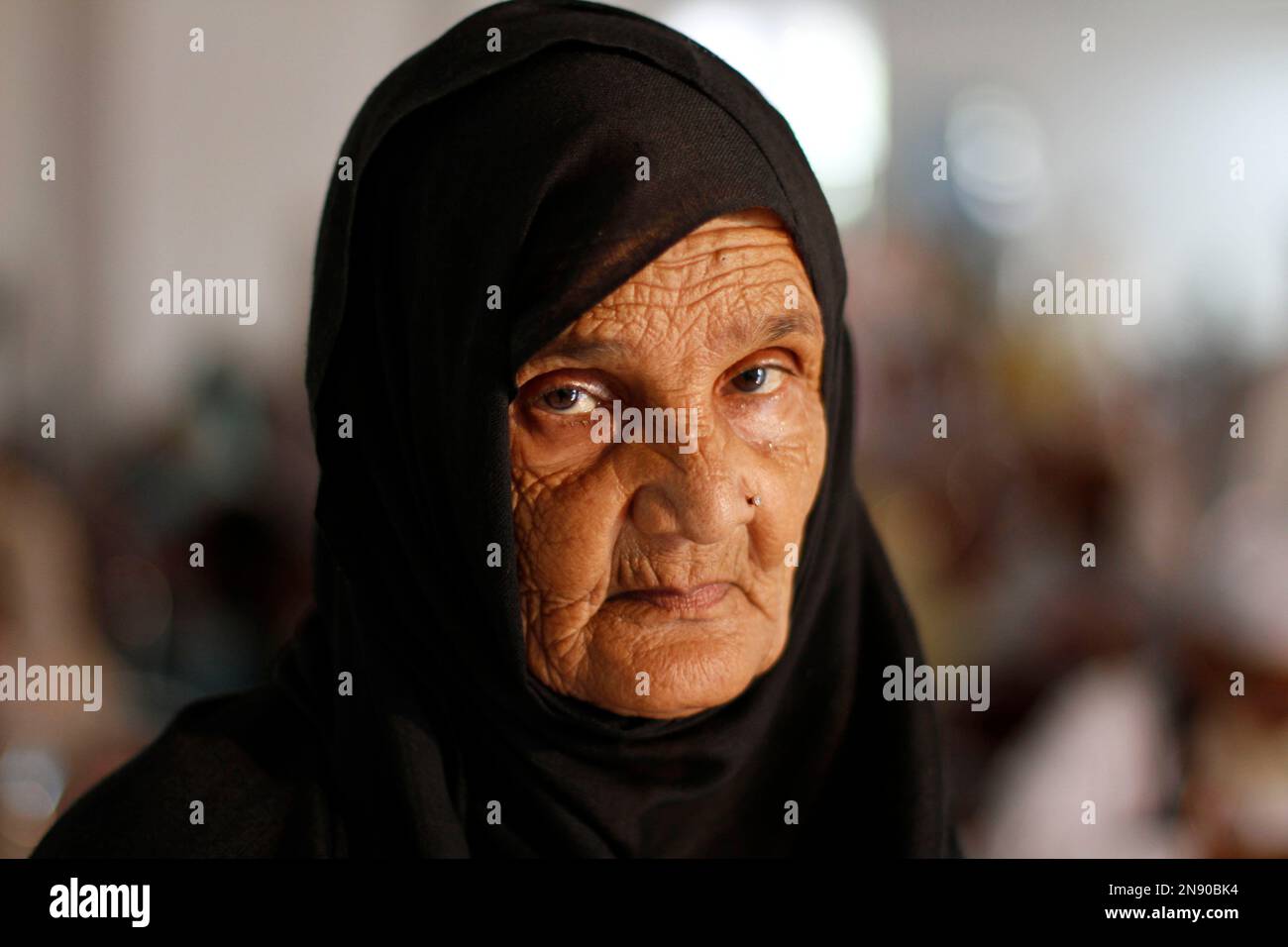 An Indian Muslim pilgrim Aziza Bibi, 52, looks at her relatives before ...