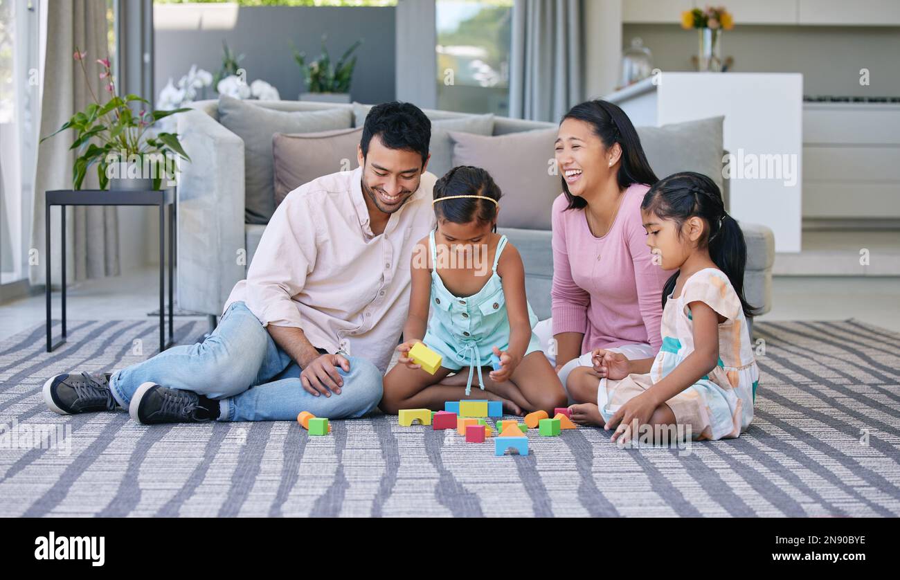 Life with kids can be interesting. a young couple playing with their ...