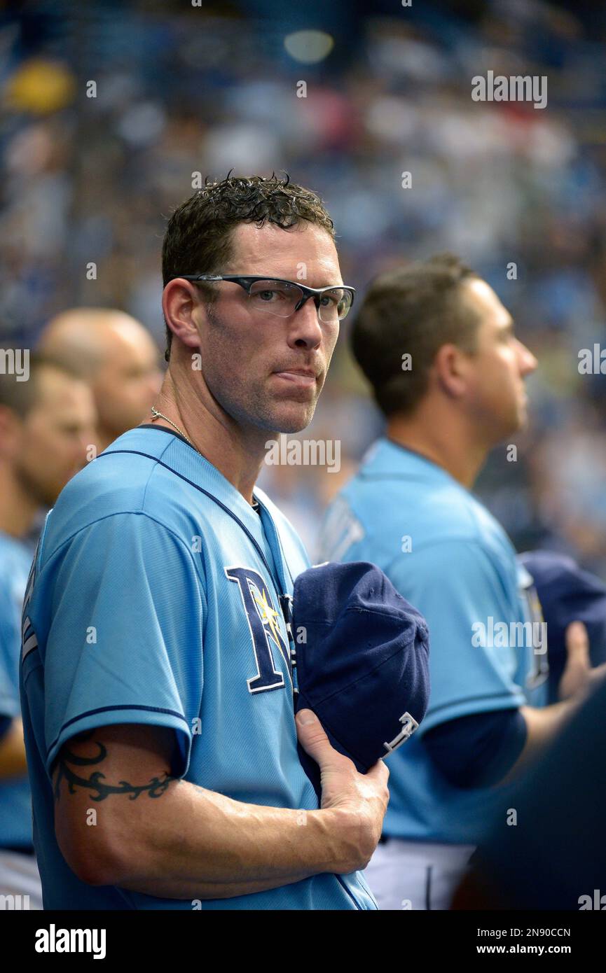Tampa Bay Rays pitcher Kyle Farnsworth, left, stands in the dugout ...