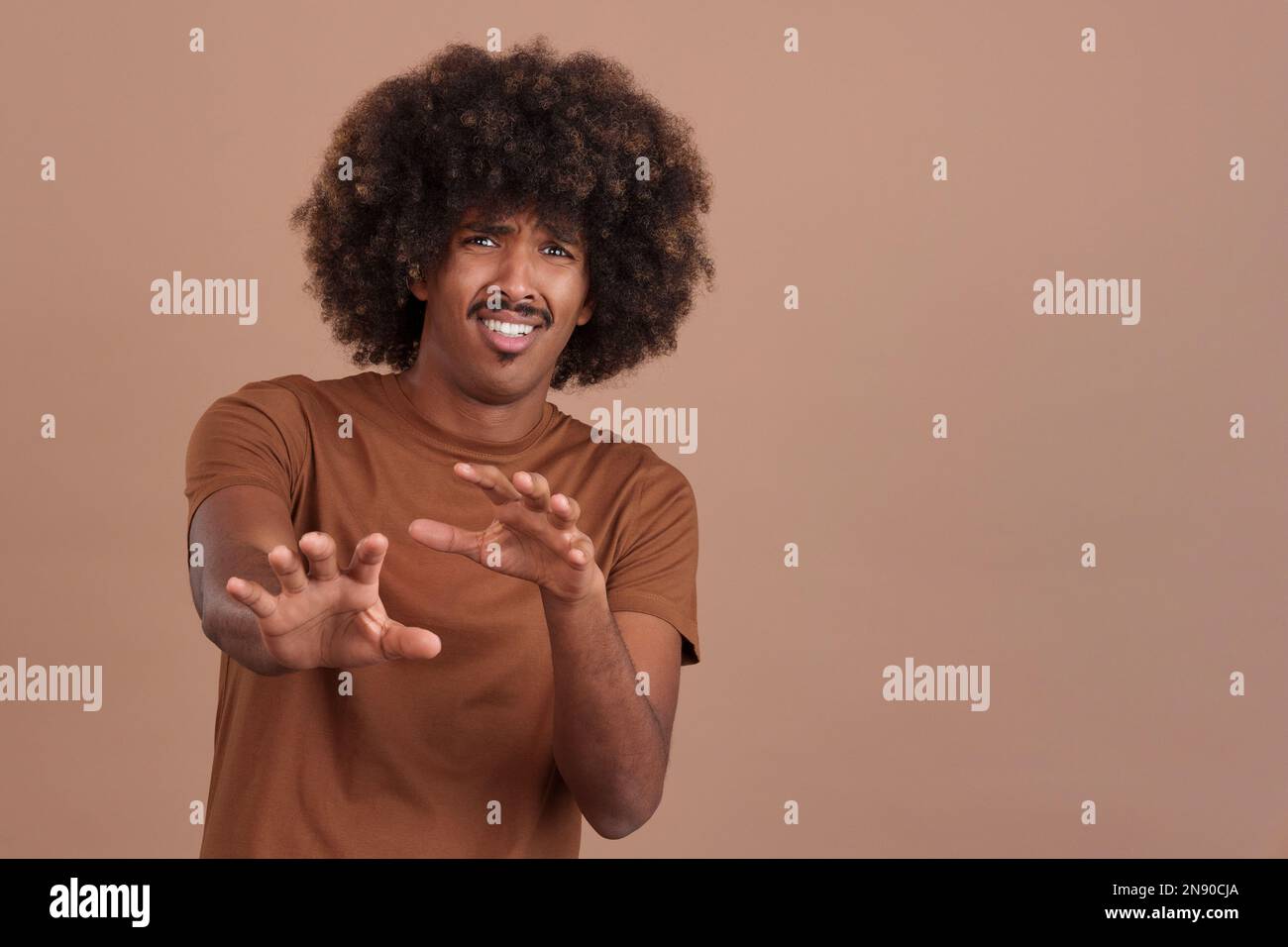 African man gesturing with the hands in fear Stock Photo - Alamy