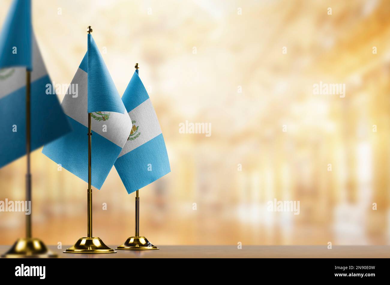 Small flags of the Guatemala on an abstract blurry background Stock ...