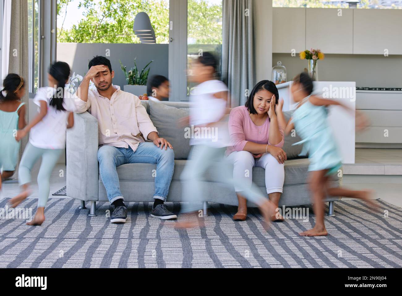 We need a getaway. two parents looking exhausted while their children ...