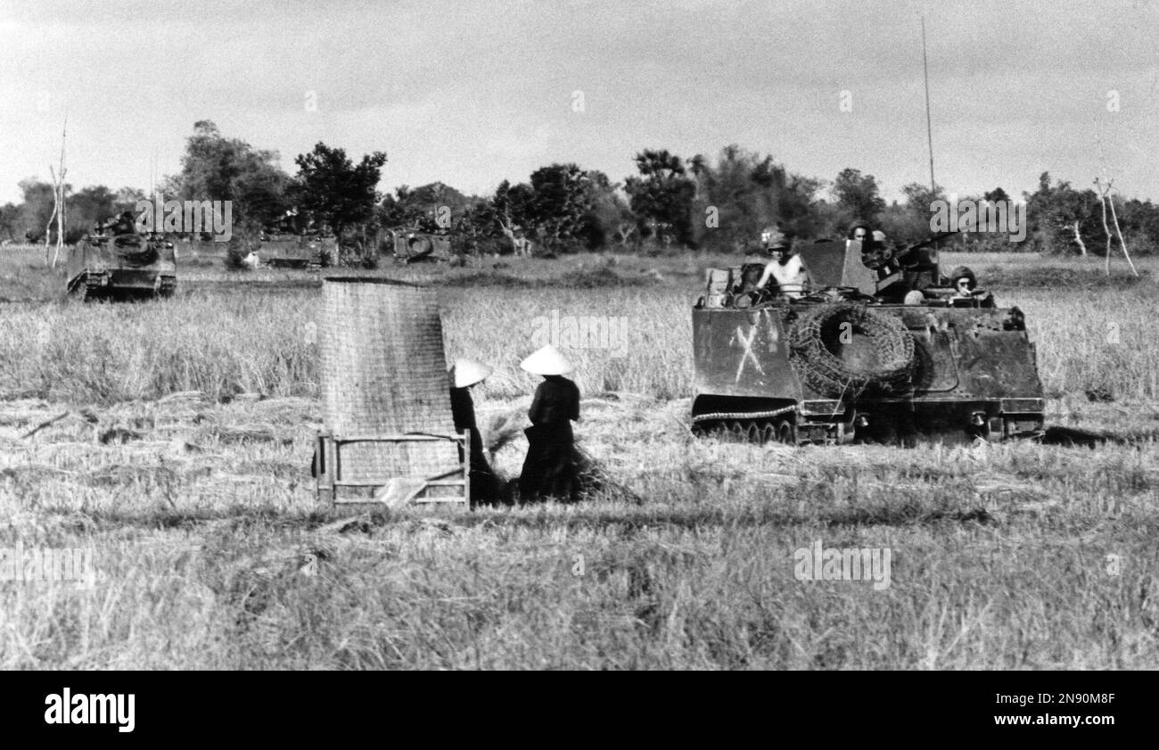 Armored personnel carriers churn through rice paddies in the Boi Loi ...