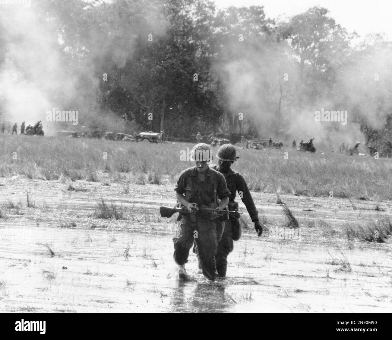 With artillery firing in the background, U.S. soldiers of the 2nd ...