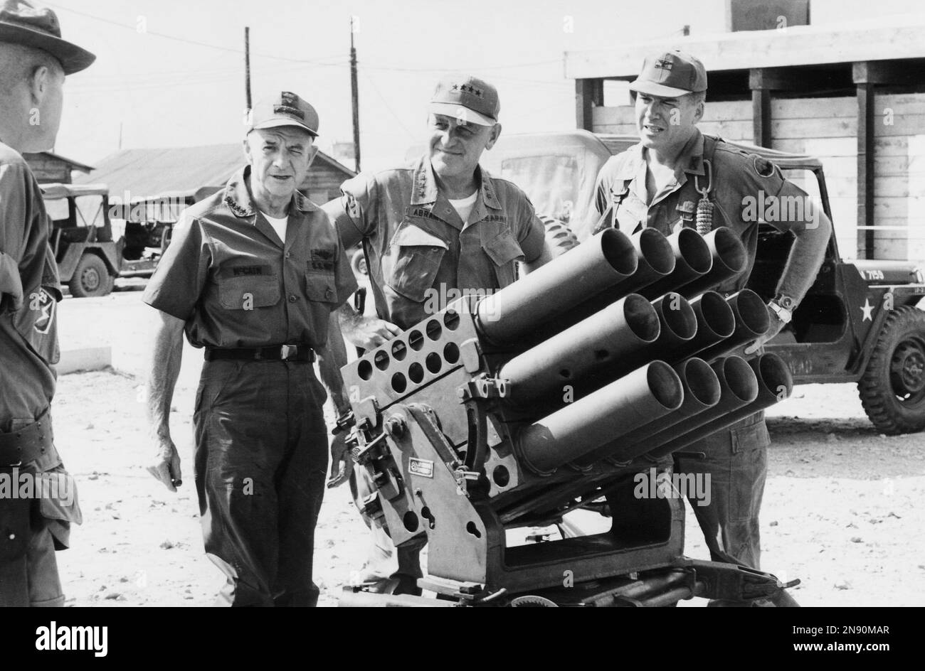 U.S. commanders inspect a captured 12-barrel 107mm rocket launcher, one ...