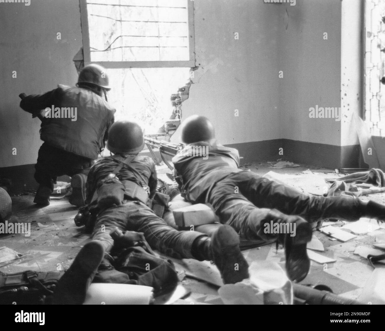Vietnamese Black Panthers fire from the second floor window of an ...