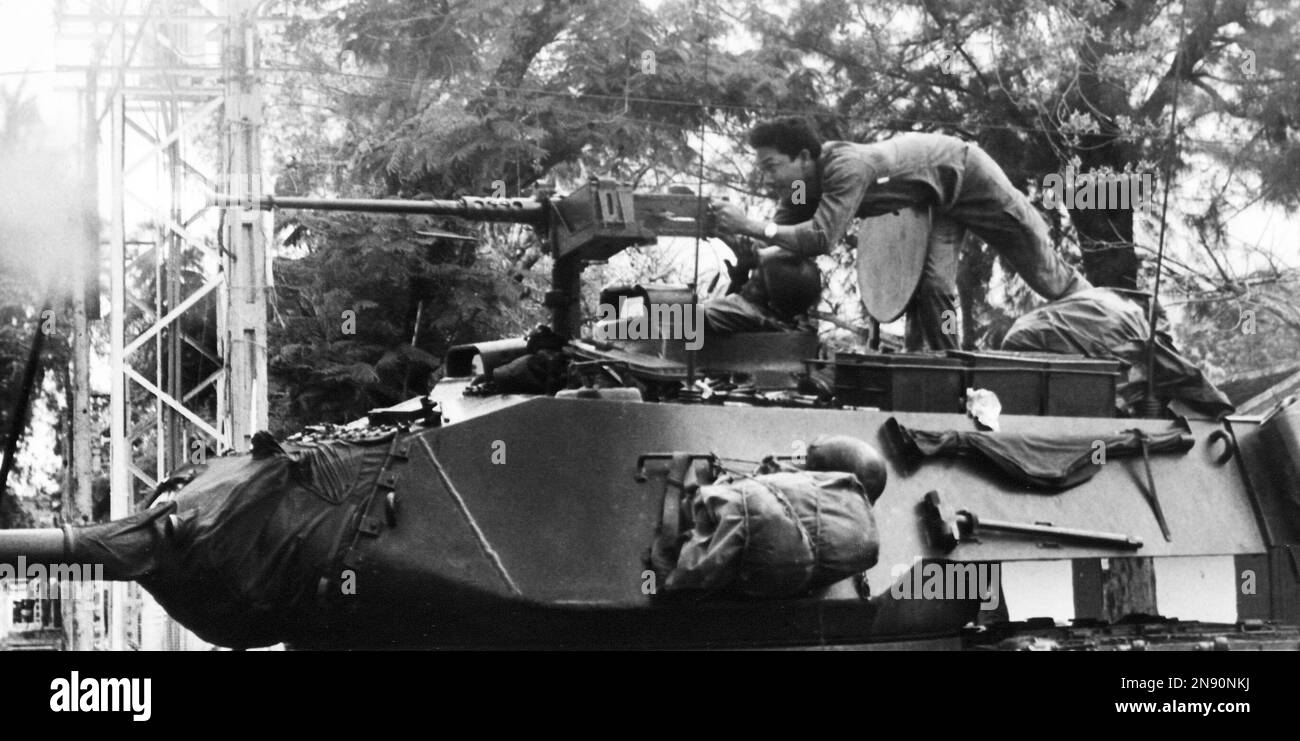 A government soldier mans a 50 caliber machine gun on a tank in Da Nang ...