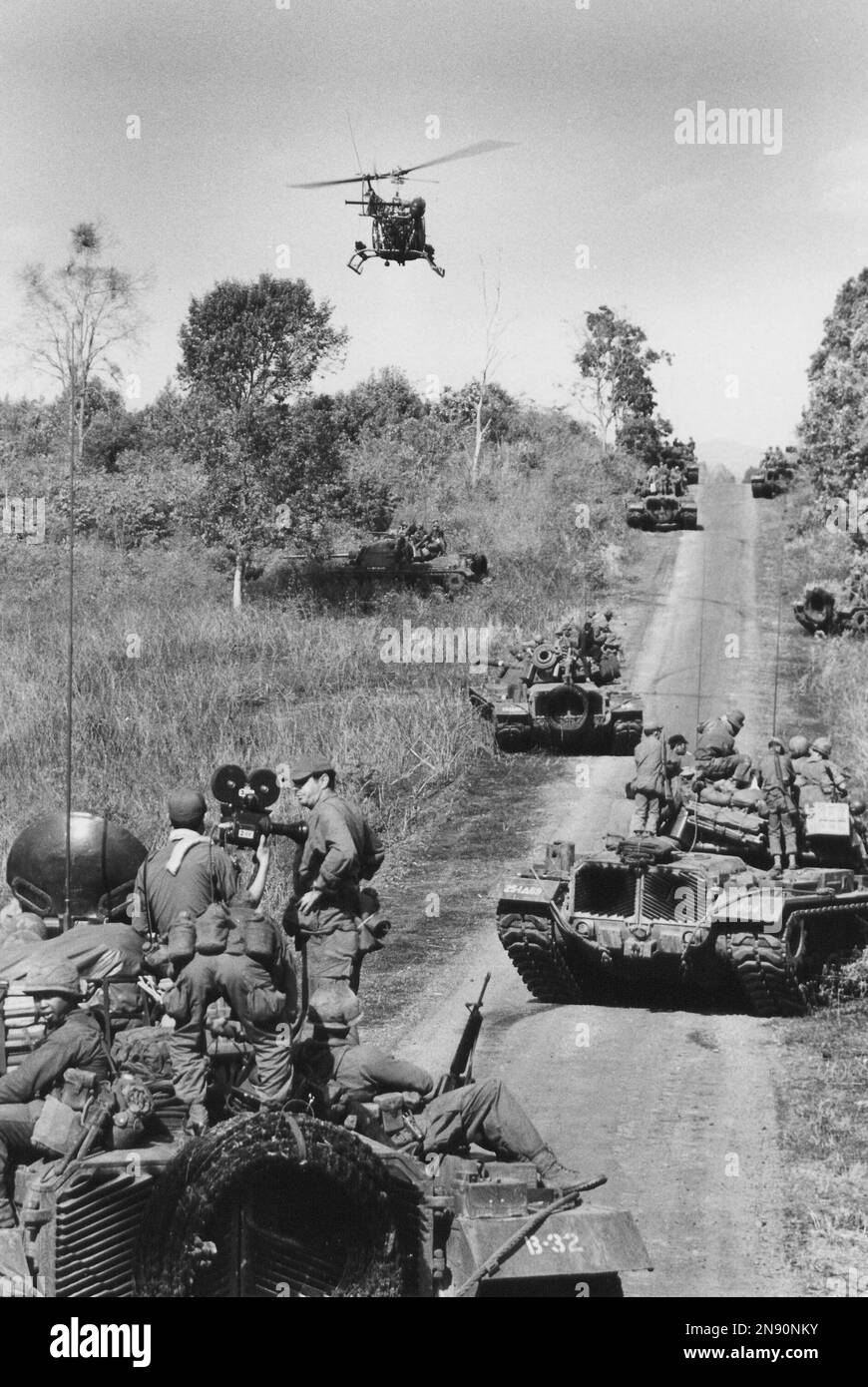 An ABC television cameraman rides atop a tank of the U.S. 25th Infantry ...