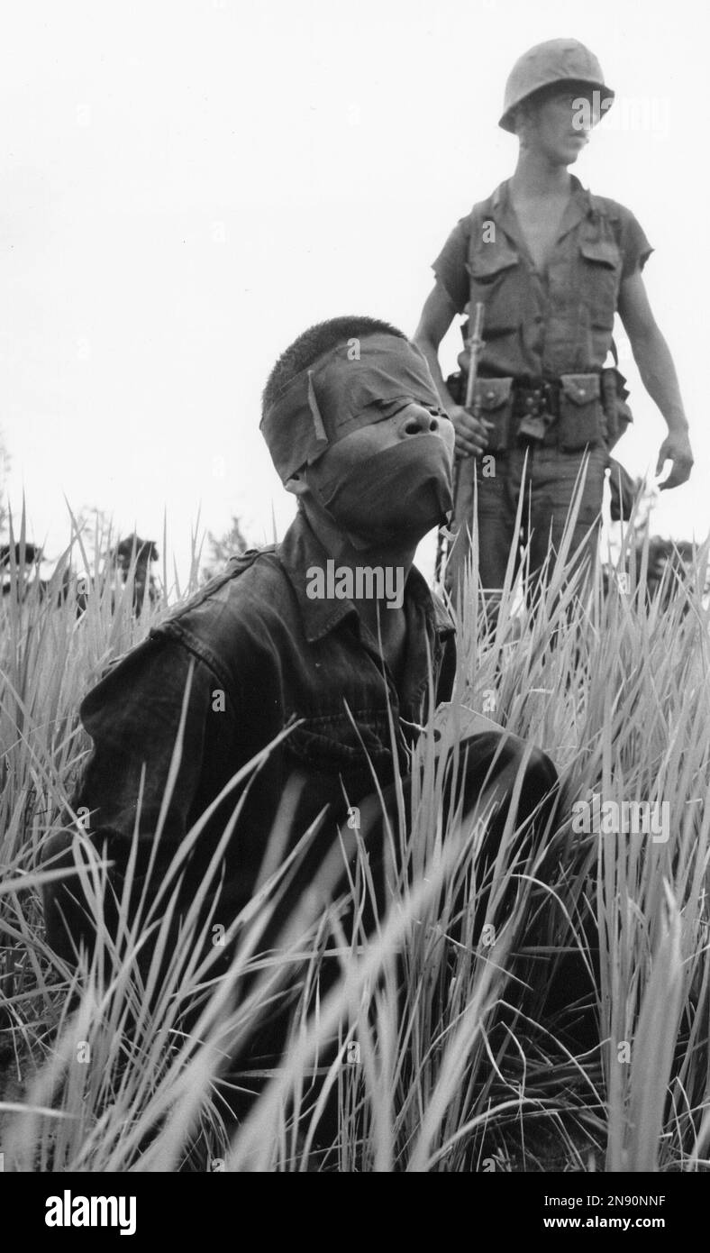Tape covers the eyes and mouth of a suspected Viet Cong guerrilla ...