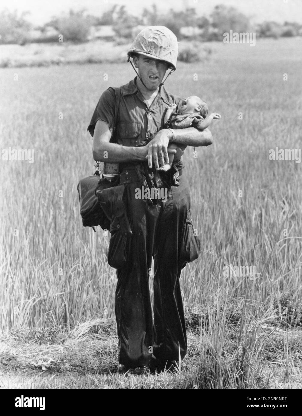A U.S. Marine carries a crying baby during the evacuation of Vietnamese ...